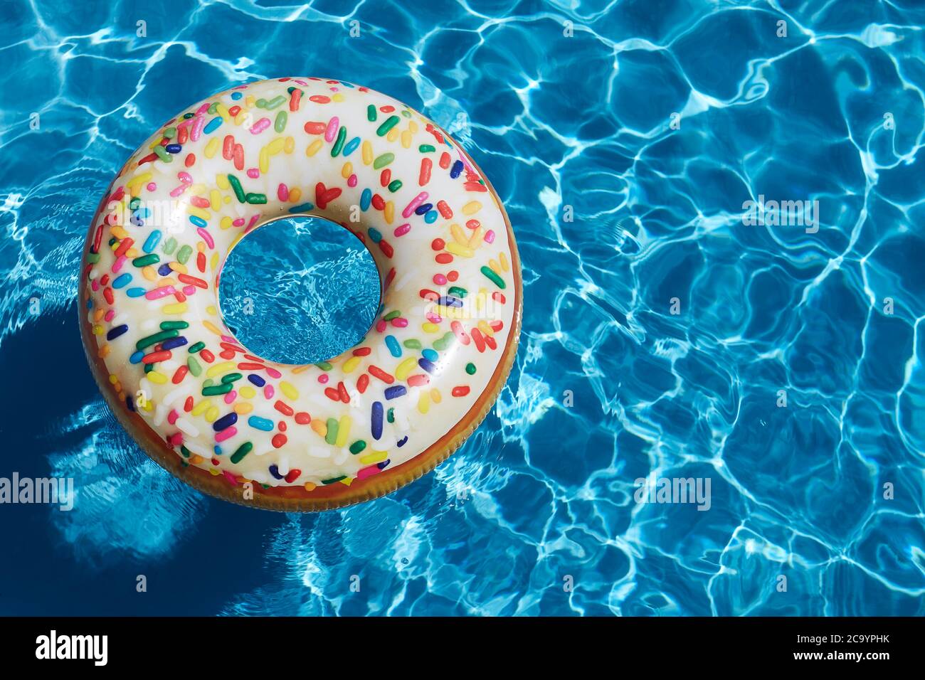 Inflatable donut ring in blue swimming pool, top view Stock Photo - Alamy
