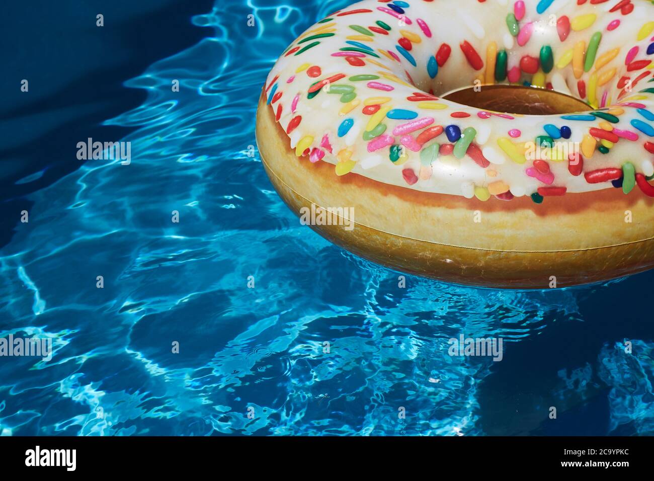 Inflatable donut ring in blue swimming pool, copy space Stock Photo - Alamy