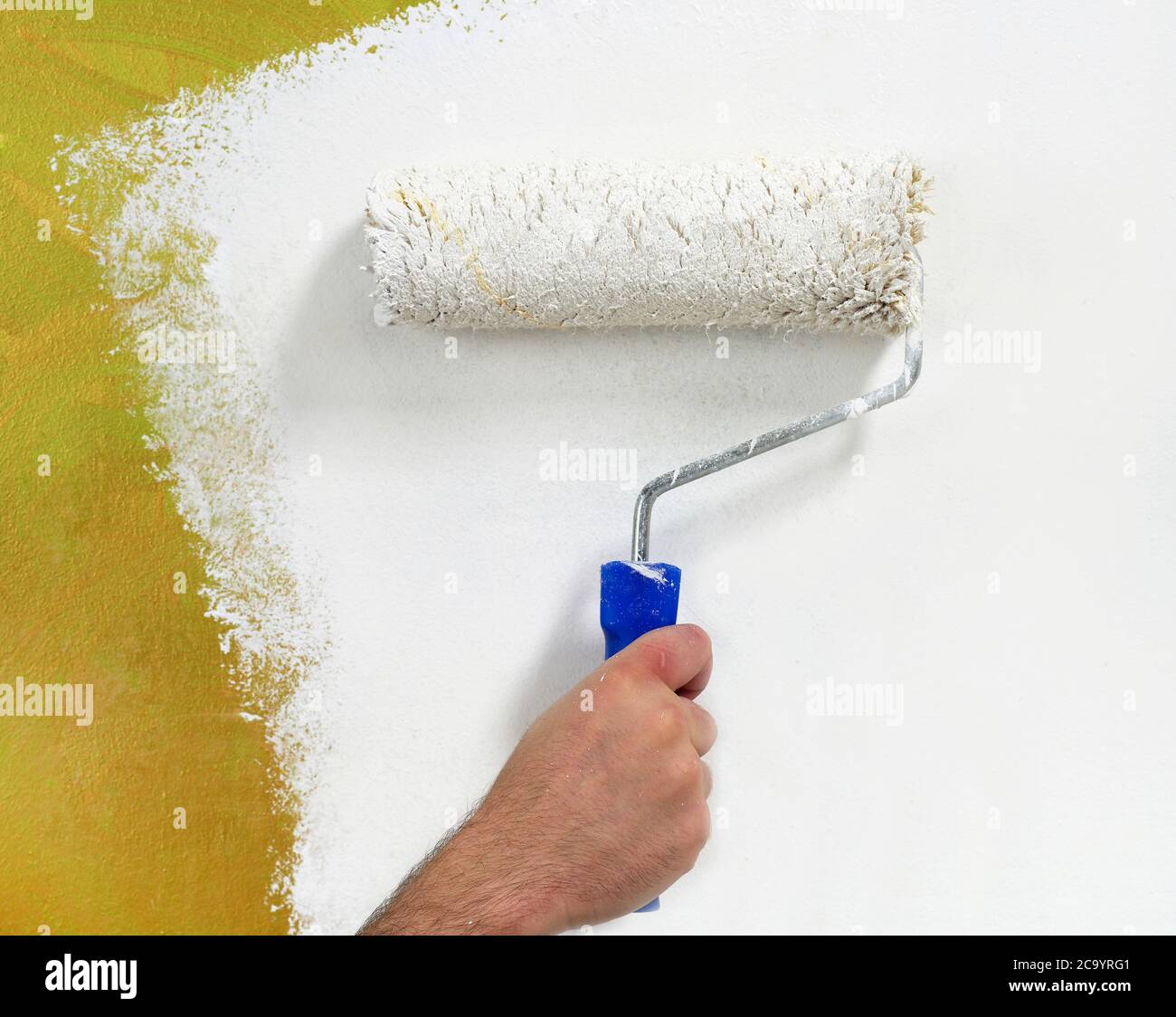 Hand with paint roller Stock Photo - Alamy