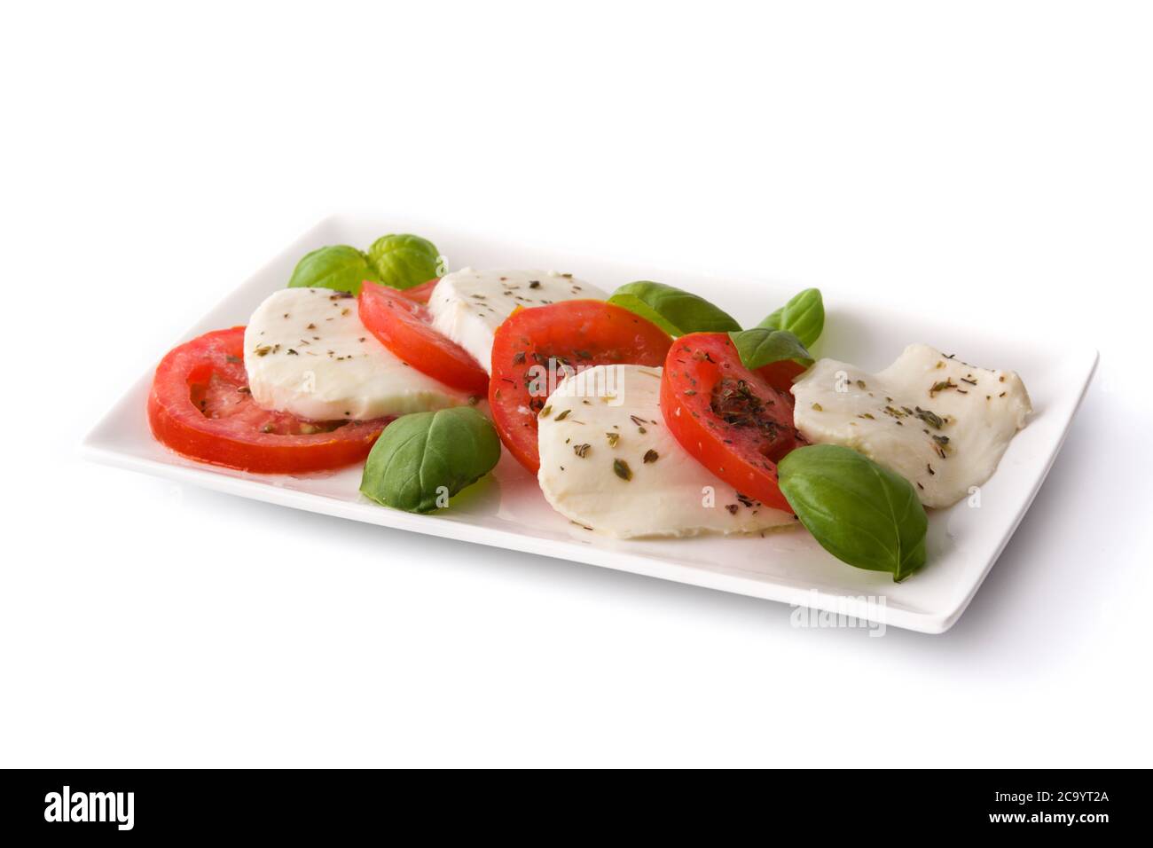 Caprese salad isolated on white background Stock Photo - Alamy