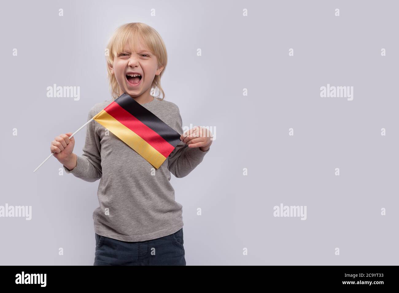 Funny boy holding flag of Germany in hand. Travel to Germany with ...