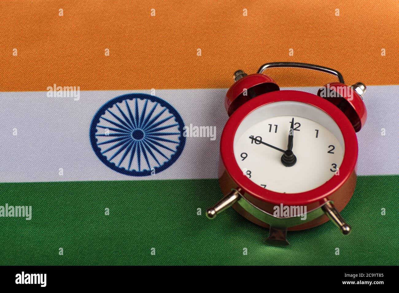 Flag of India and the old alarm clock close up. Traveling to India ...