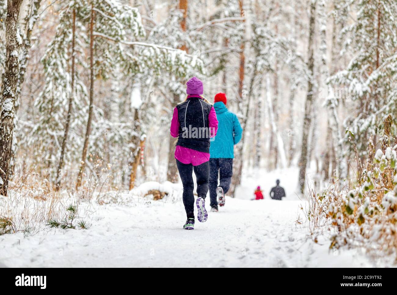 Male and female runners running in forest hi-res stock photography and ...