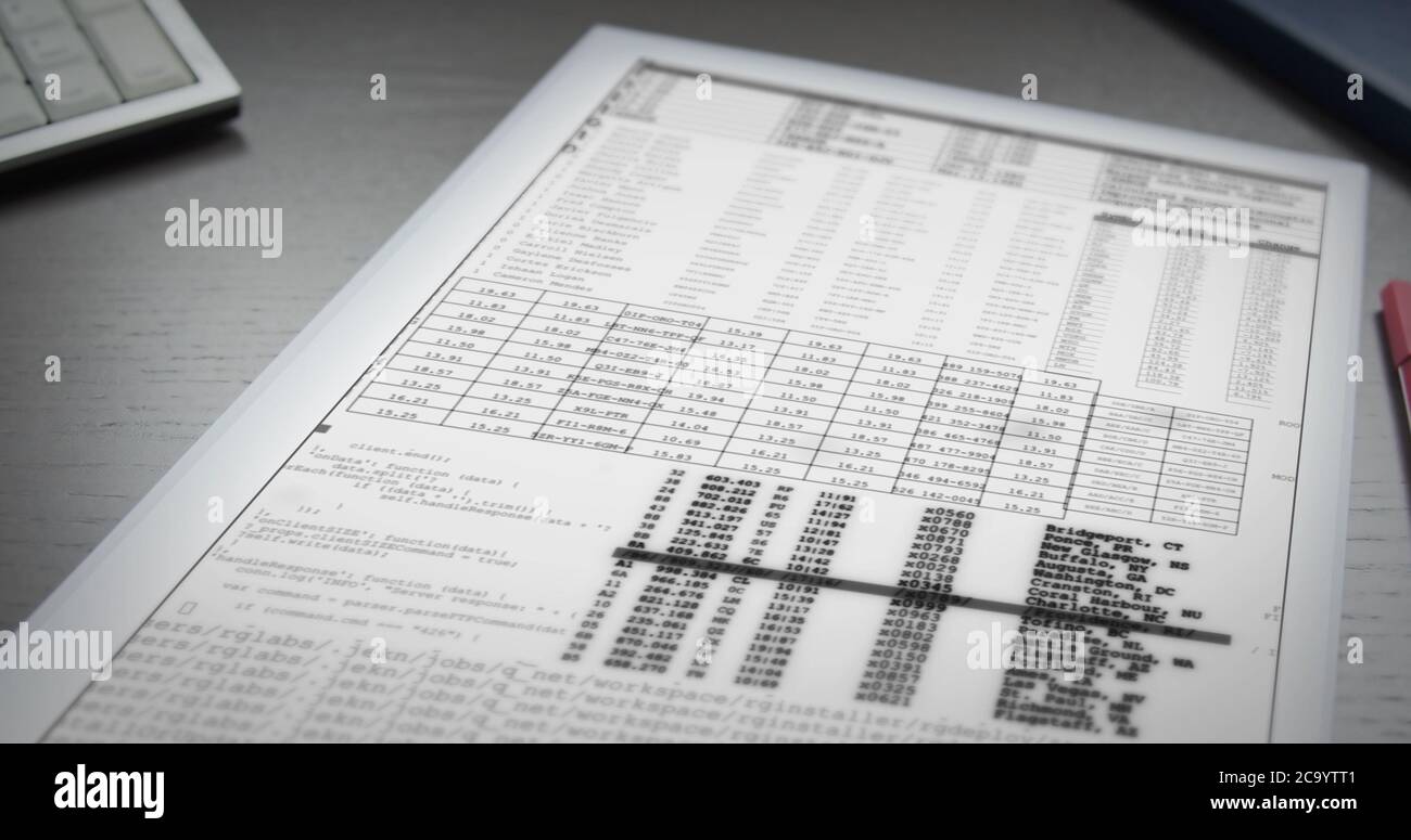 Sheet of white paper with digital numbers and code lies on table Stock ...