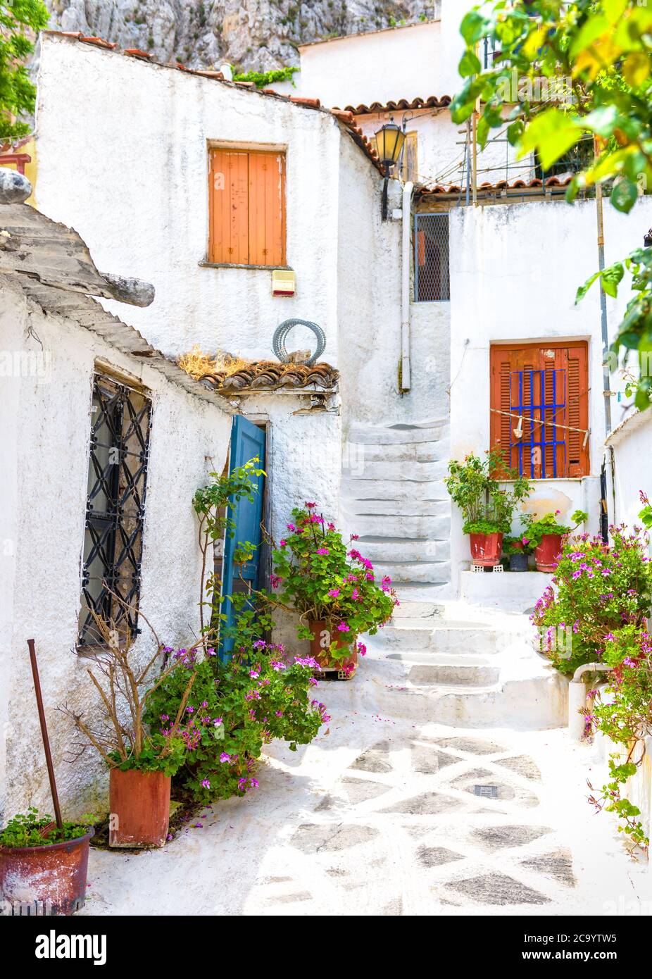 Old narrow street with flowers in Anafiotika, Plaka district, Athens ...