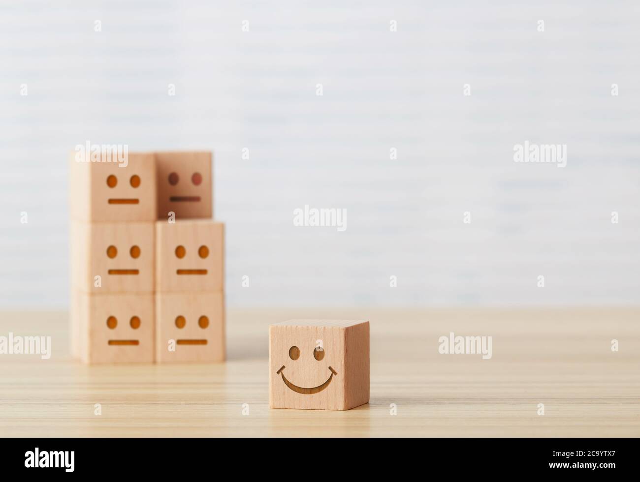Smiley face on wooden cube Stock Photo - Alamy