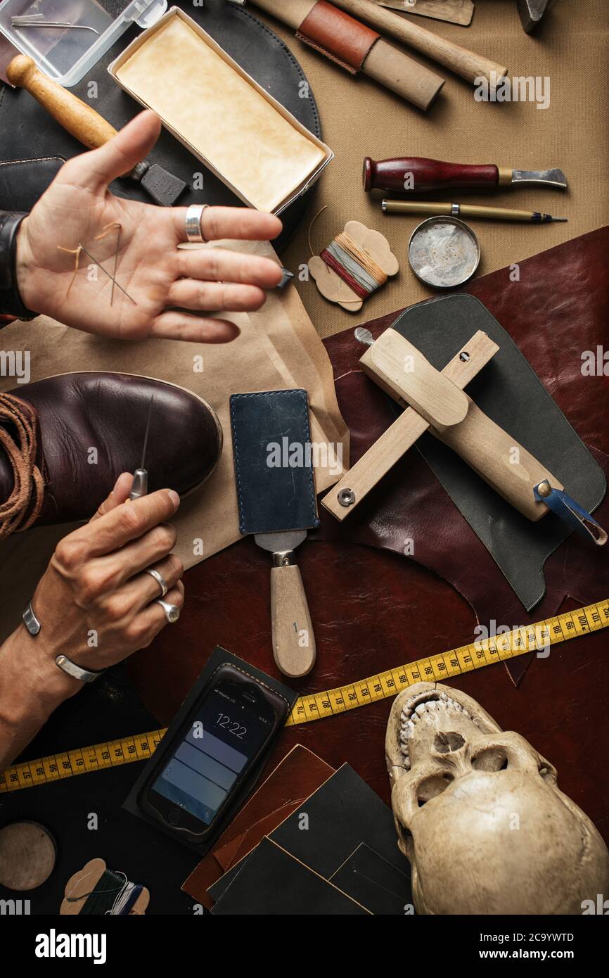 Enjoying process of creation custom made shoes. Workplace of shoe ...