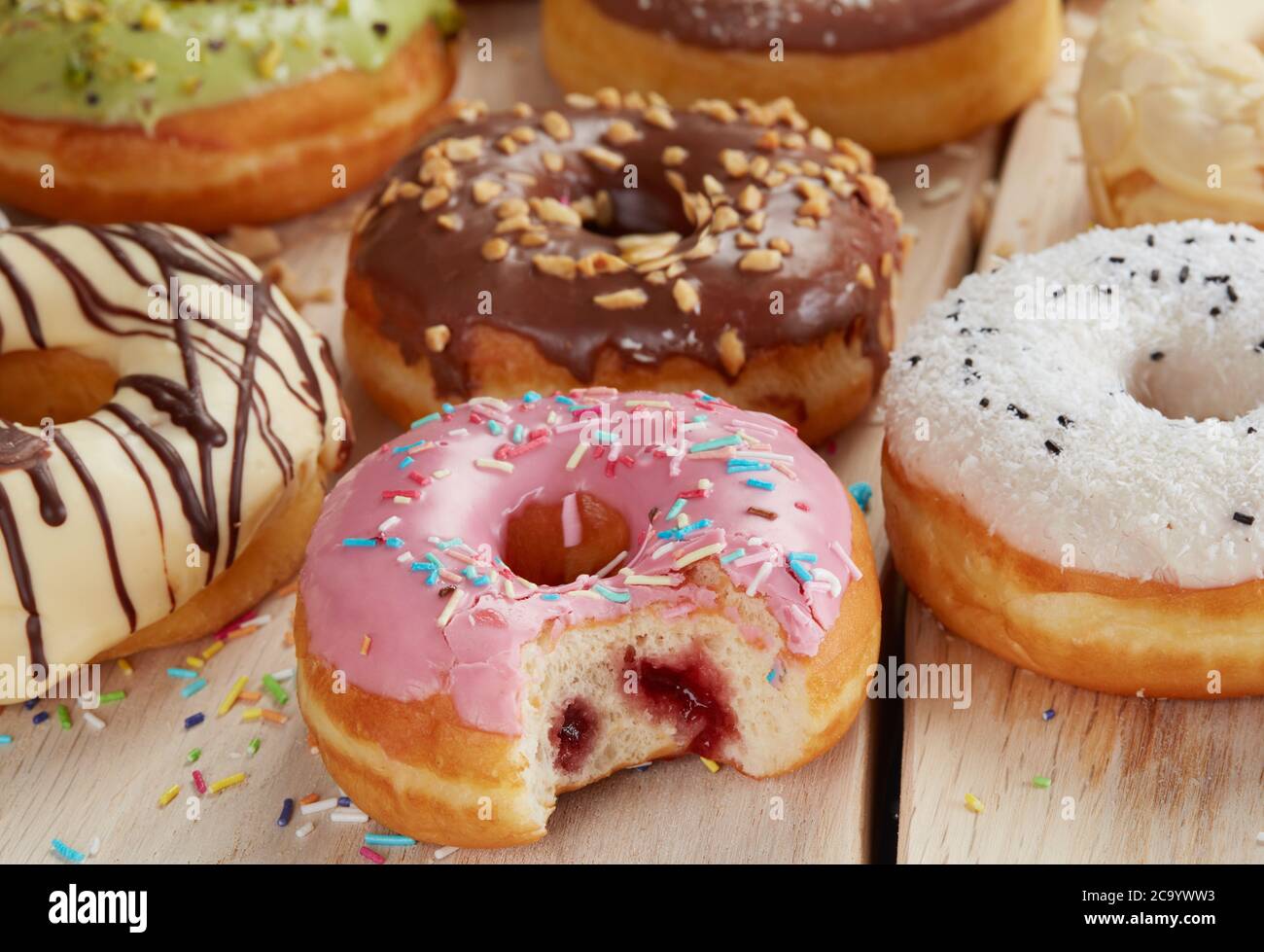 Delicious donuts on wood table Stock Photo - Alamy