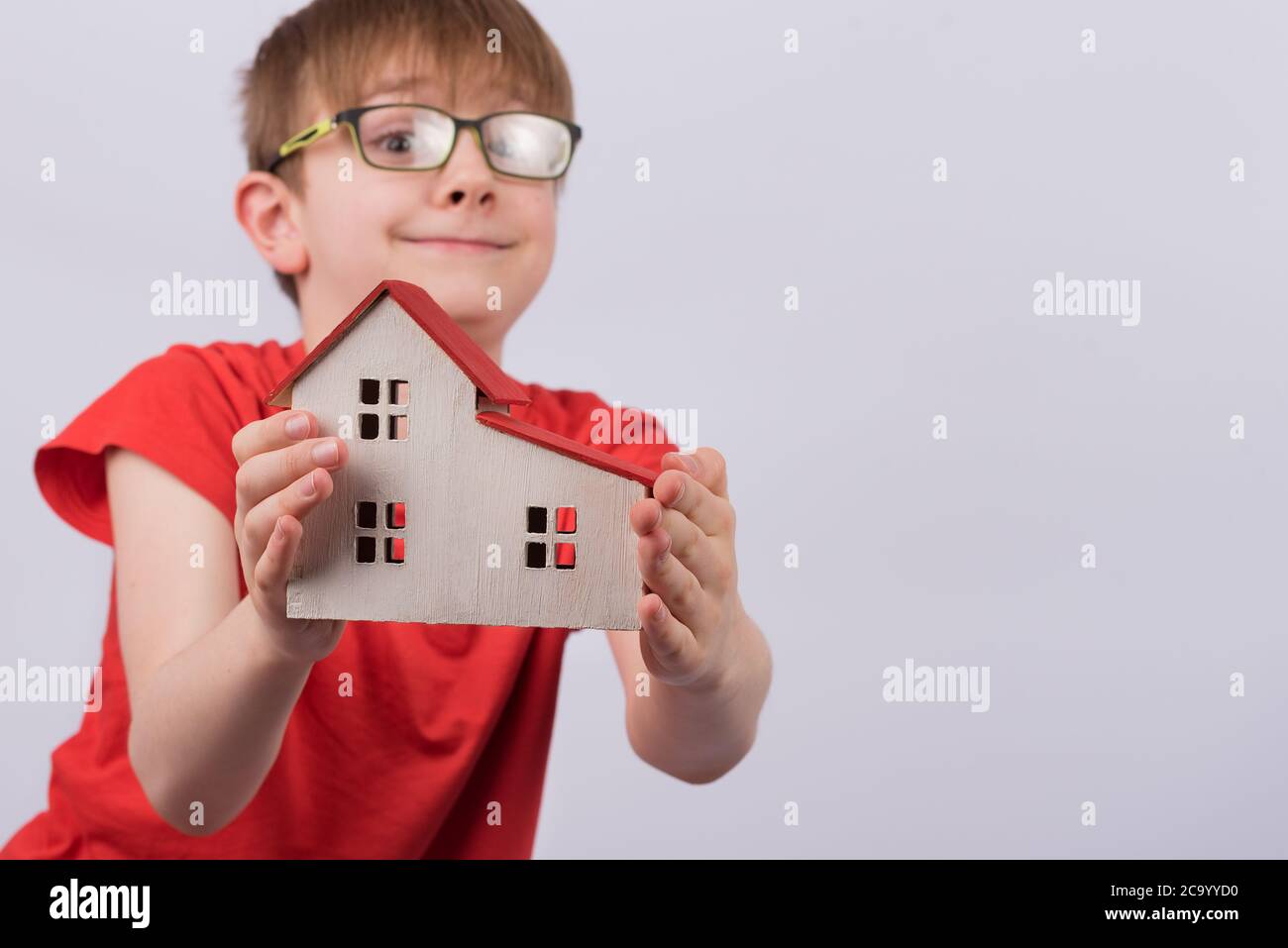 Happy boy shows model home. Real estate, family home, foster home care ...