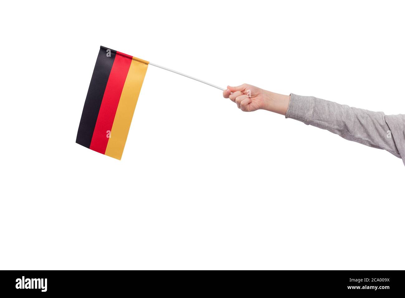 Childrens hand holds flag of Germany isolated on white background ...