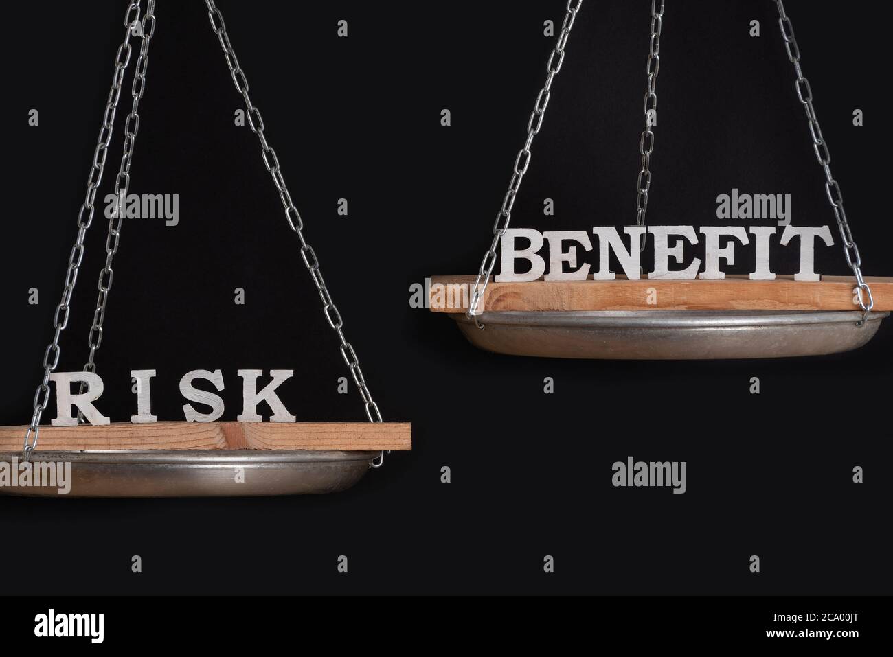 Risk and benefit reward concept. Scales on black background close up ...