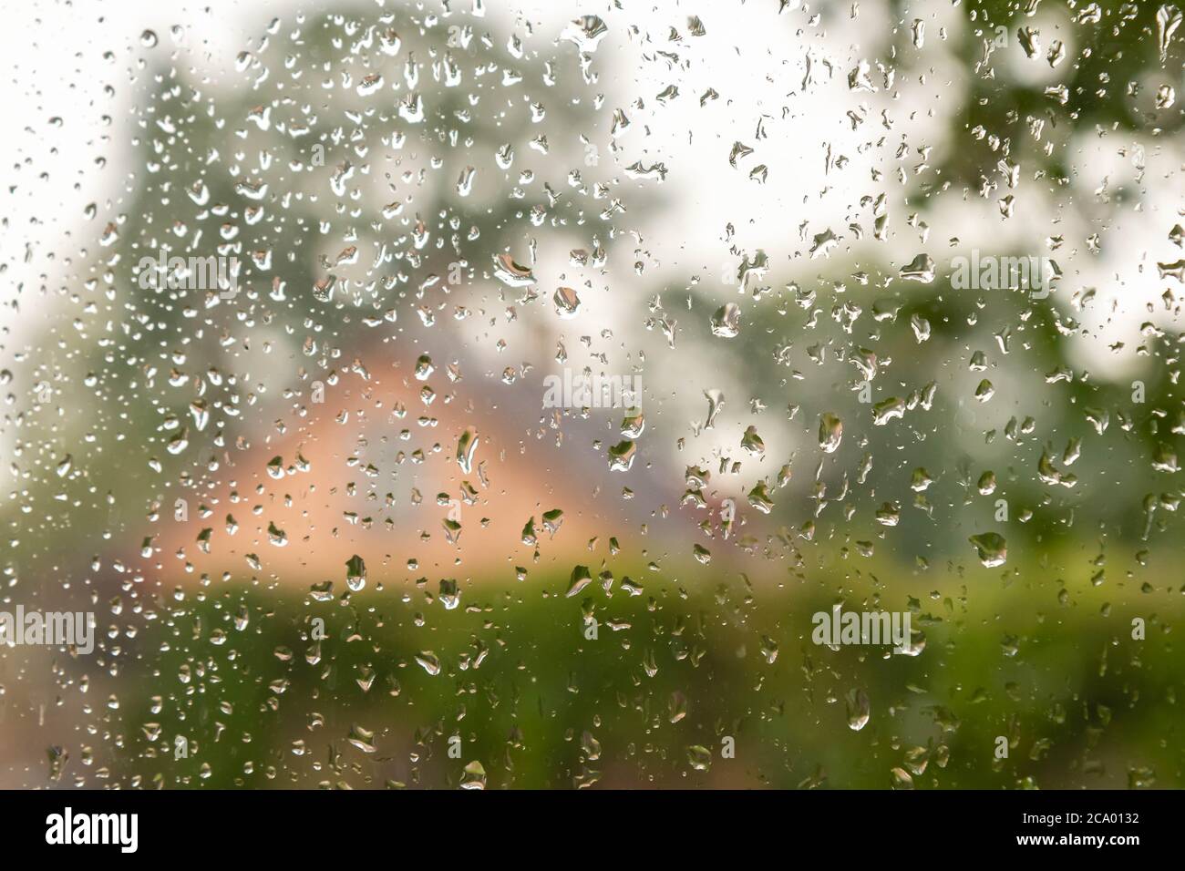 Water drops on window. Autumn rural landscape through raindrops on the ...