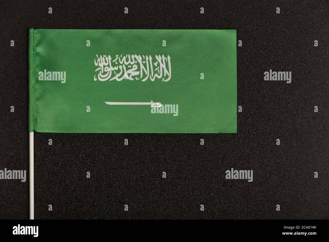 Table flag of Kingdom of Saudi Arabia on black background. Green flag ...