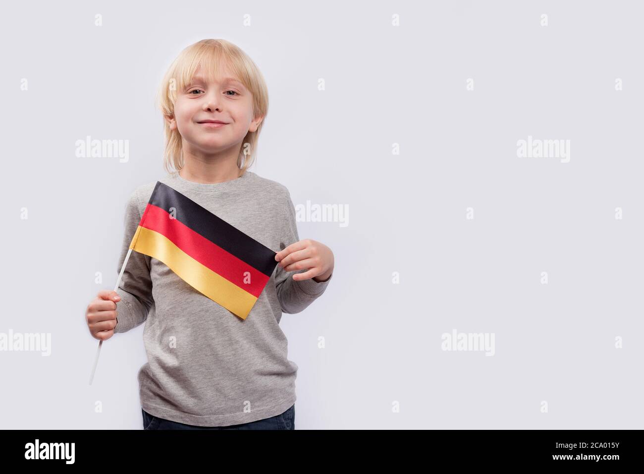 Blonde German boy with national flag in hands. Patriotism in Germany ...