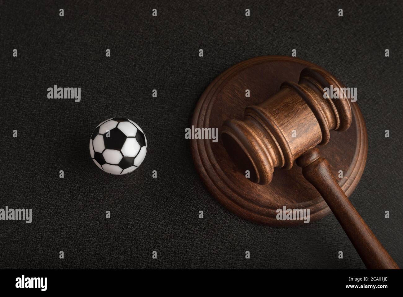 Wooden judge gavel and toy soccer ball. Football coach accused ...