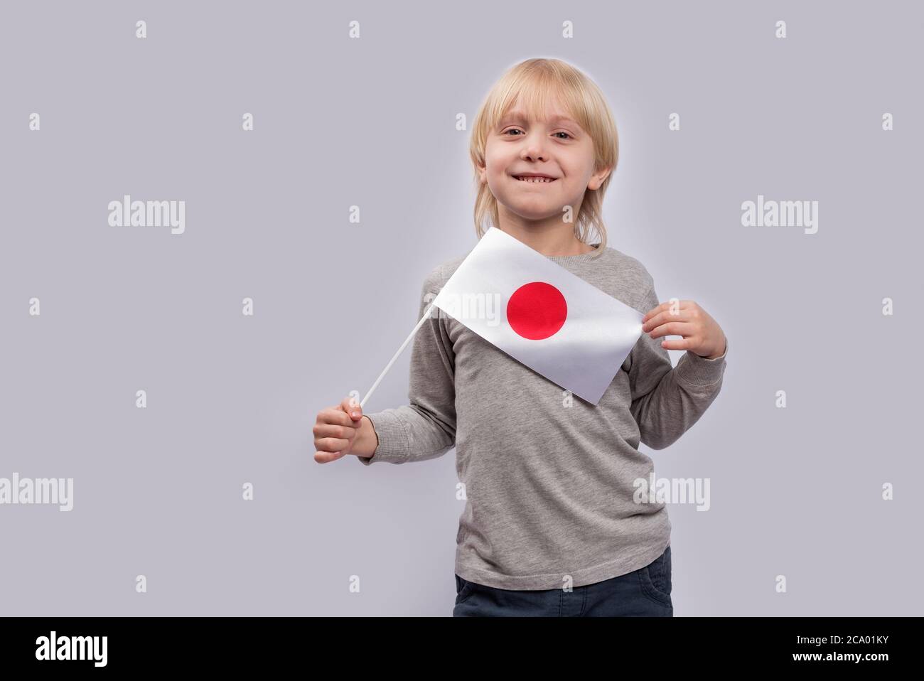 Smiling boy with Japan flag in hands. Education in Japan. Learning ...