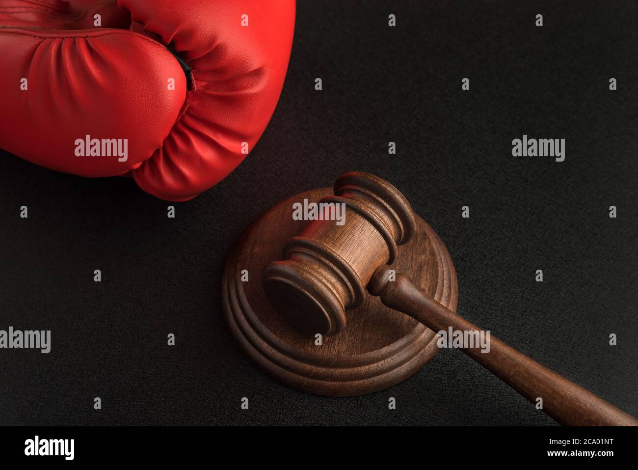 Wooden judge gavel and Boxing glove. Sports suits. Confrontation in ...