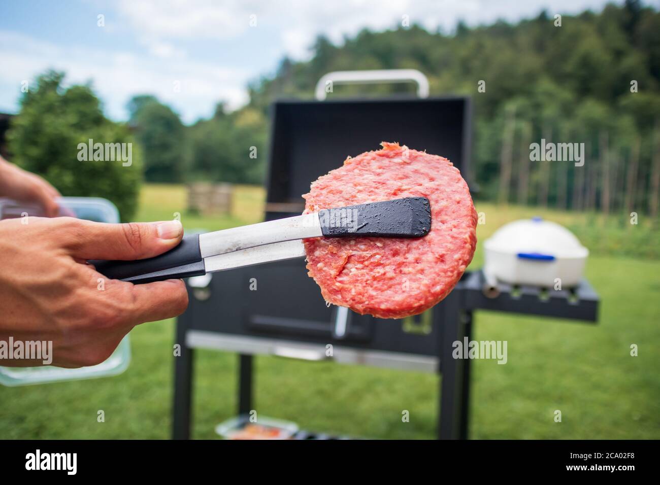 Home barbecue with charcoal in the backyard grilling steaks and other ...