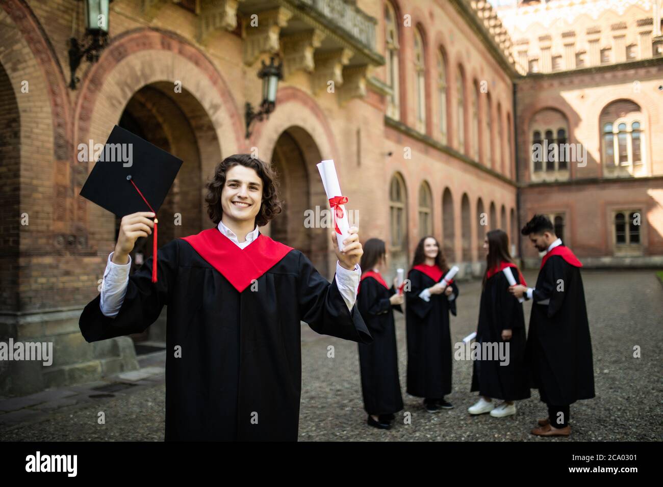 graduation man in front of a group of graduation students Stock Photo ...
