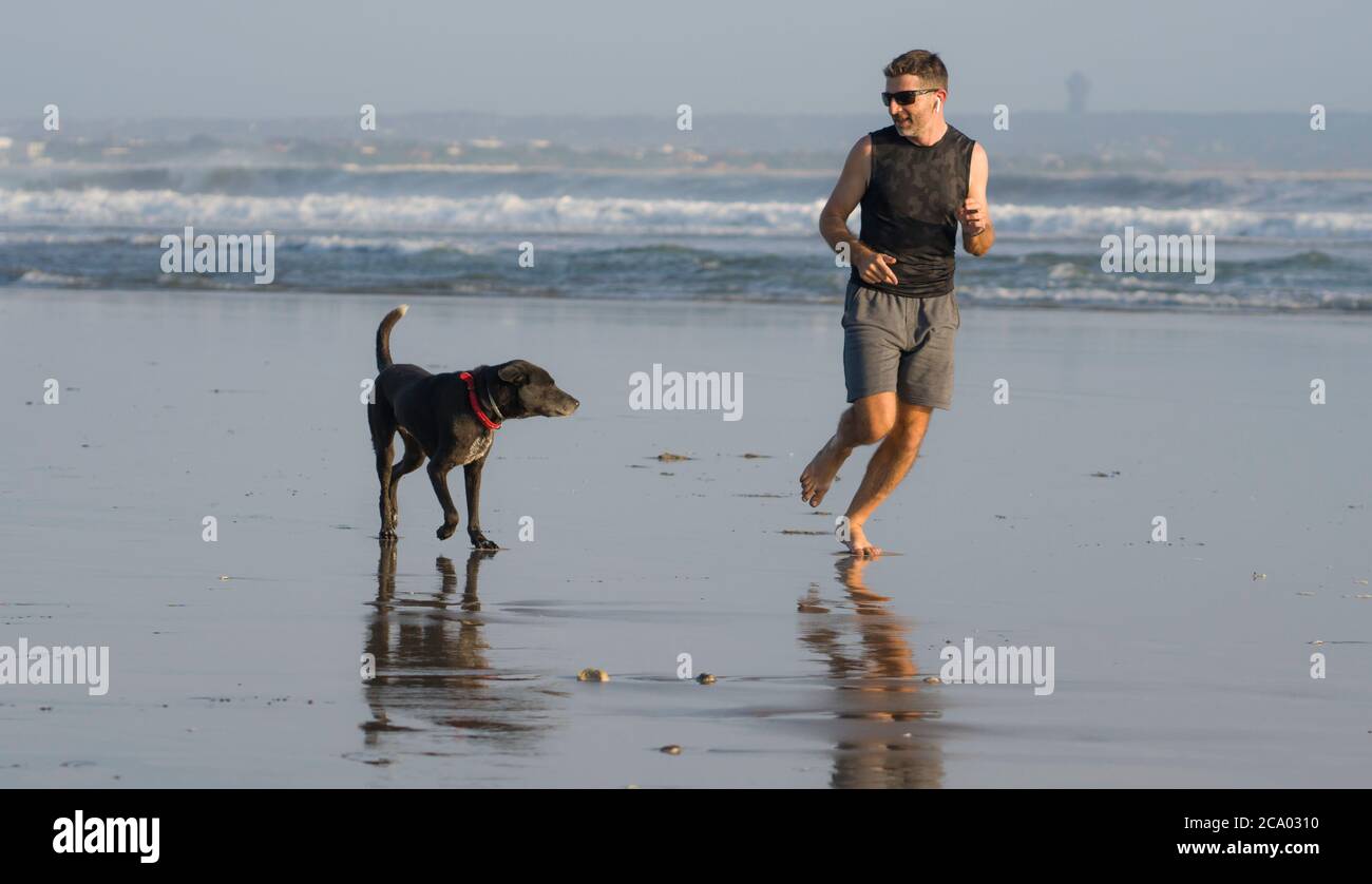 Man jog dog in beach hi-res stock photography and images - Alamy