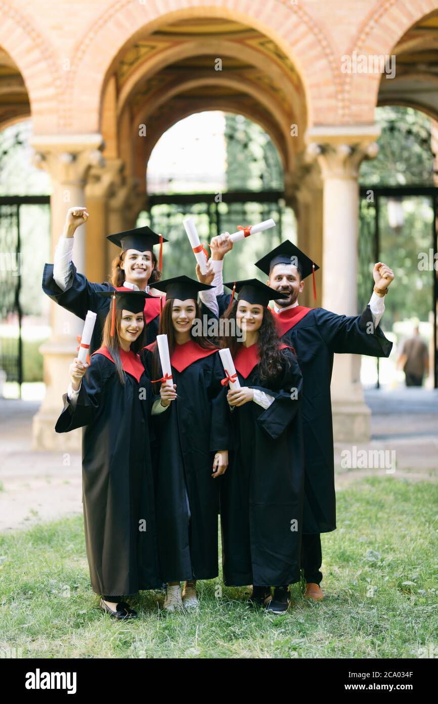 Group of graduate students holding their diploma after graduation Stock ...