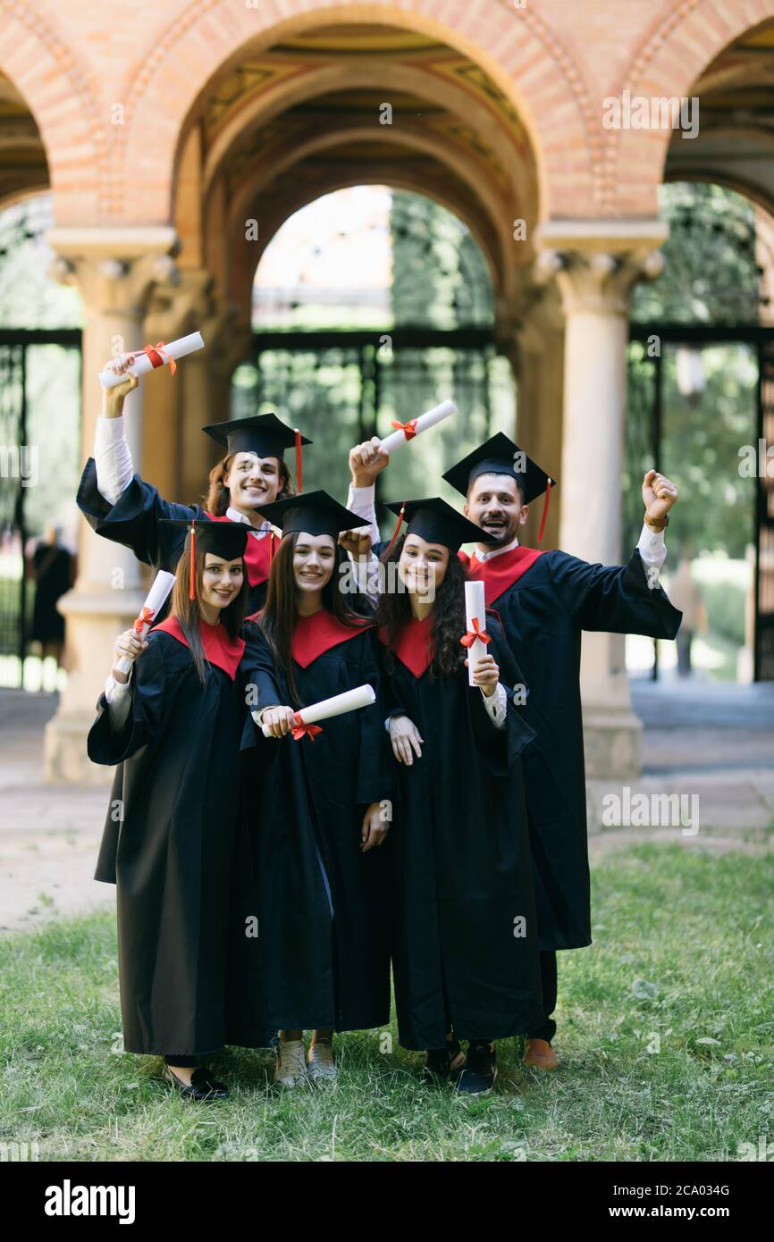 Group of graduate students holding their diploma after graduation Stock ...