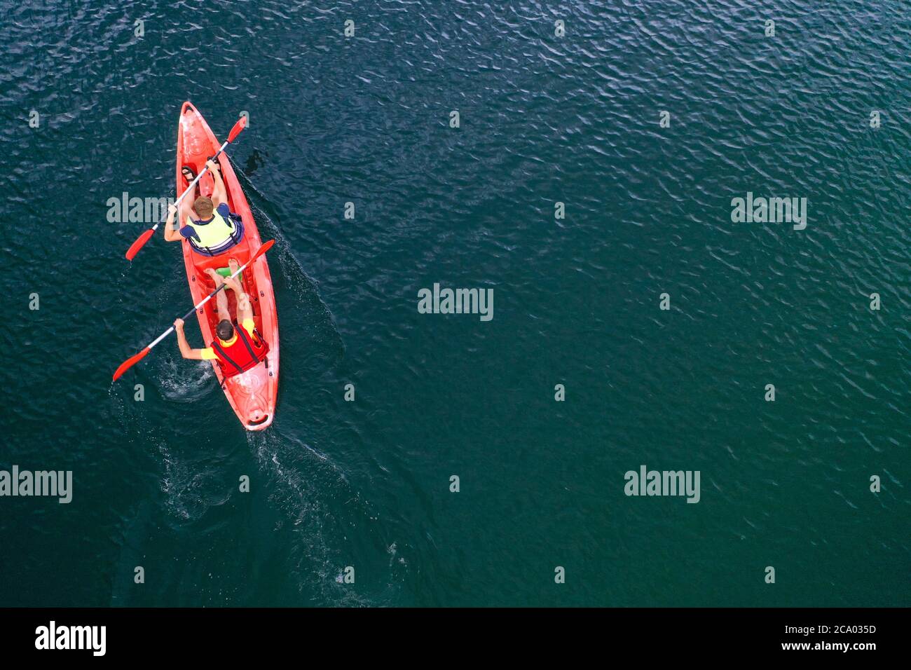 kayak floats on the river aerial view, top view from a drone, two guys ...