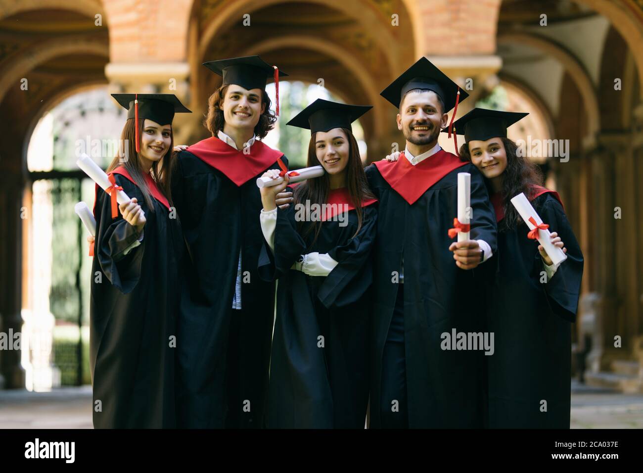Group of graduate students holding their diploma after graduation Stock ...