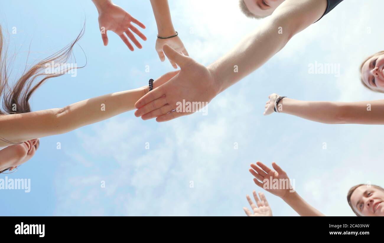 Friendly friends clasp hands as a sign of strong friendship and ...