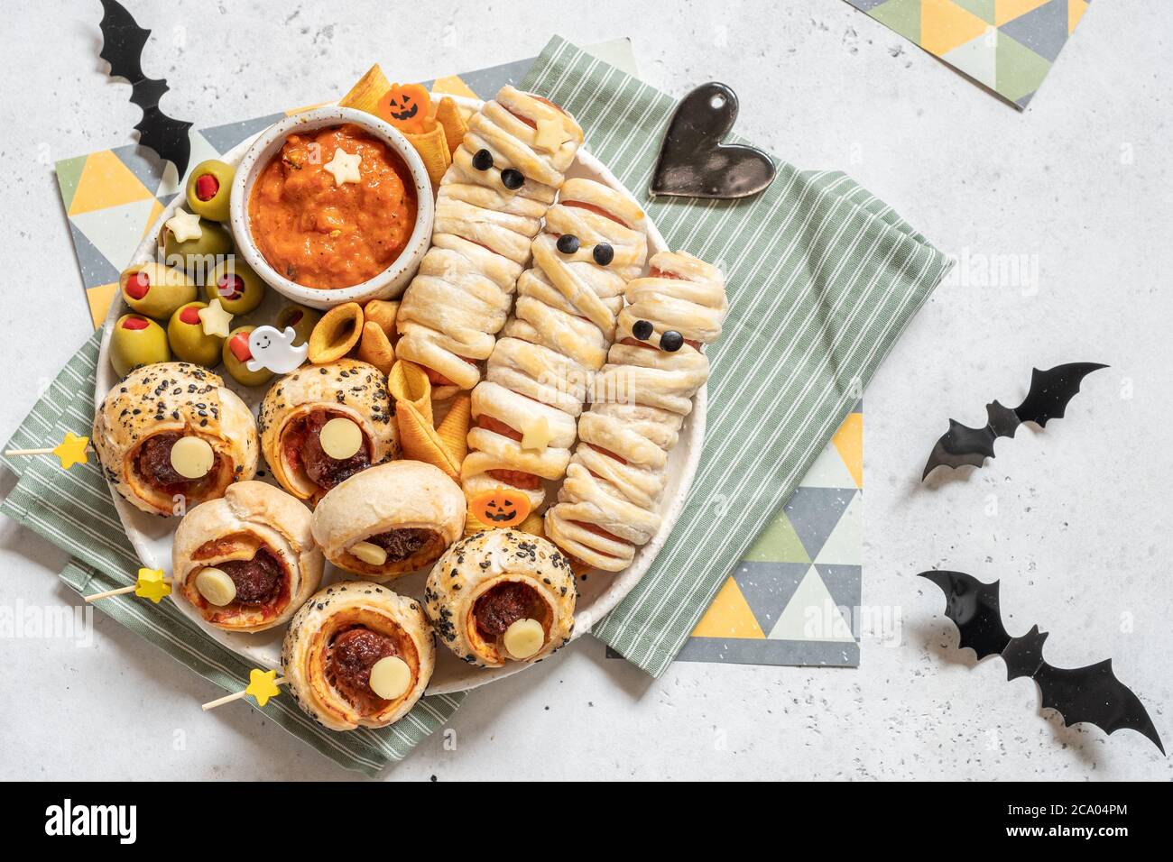 Halloween sausage mummies in dough with funny eyes on table Stock Photo ...