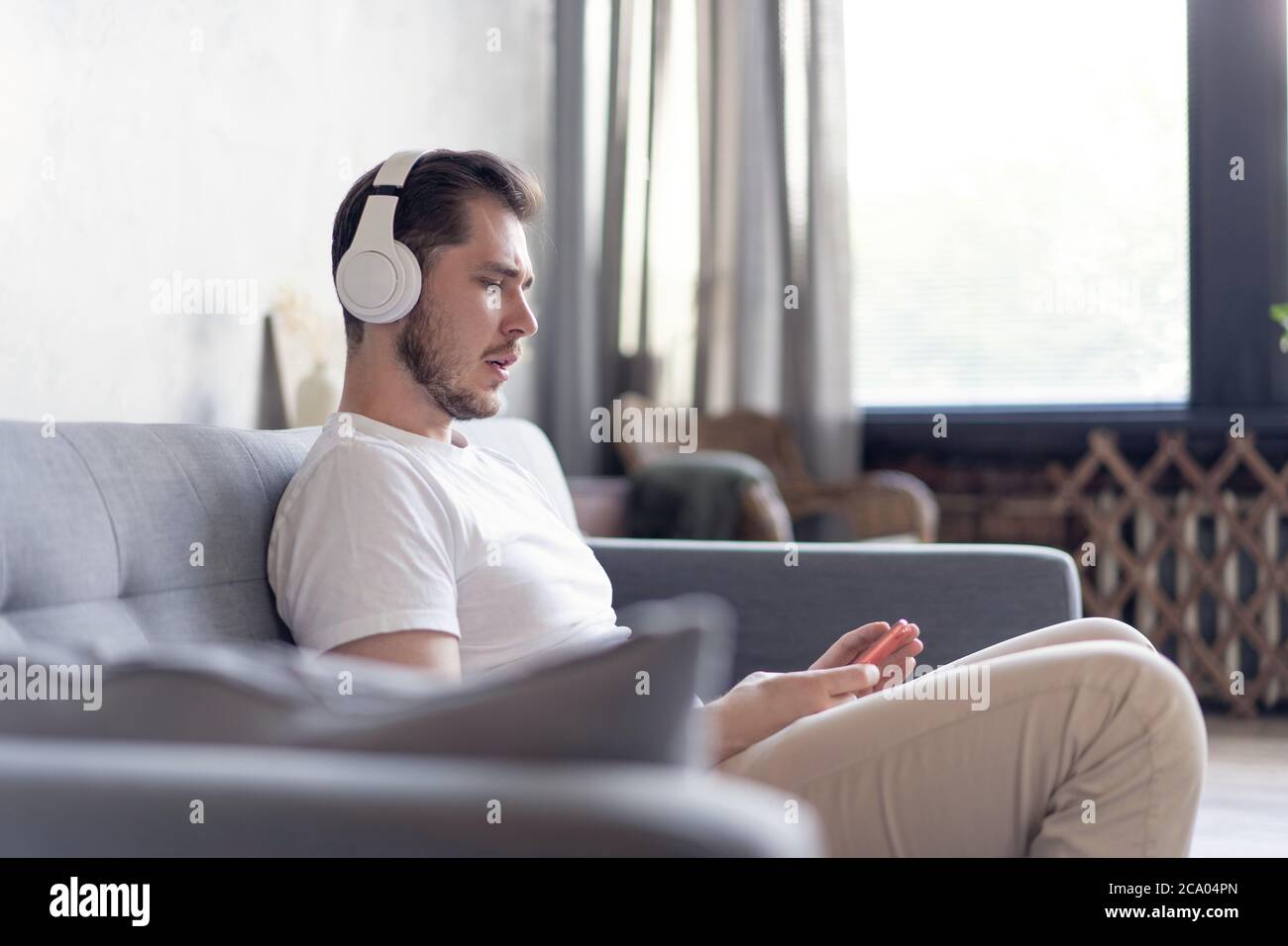Enjoying His Favorite Music Cheerful Young Man In Headphones Listening