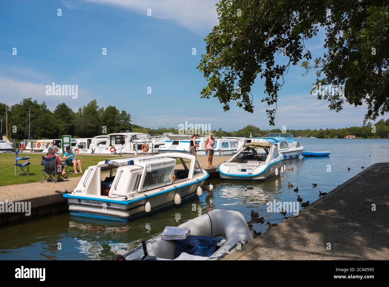Norfolk Broads, view in summer of pleasure boats moored along the quay ...