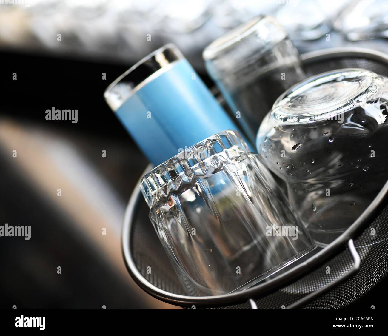 Glass utensils drying out in a sieve Stock Photo - Alamy