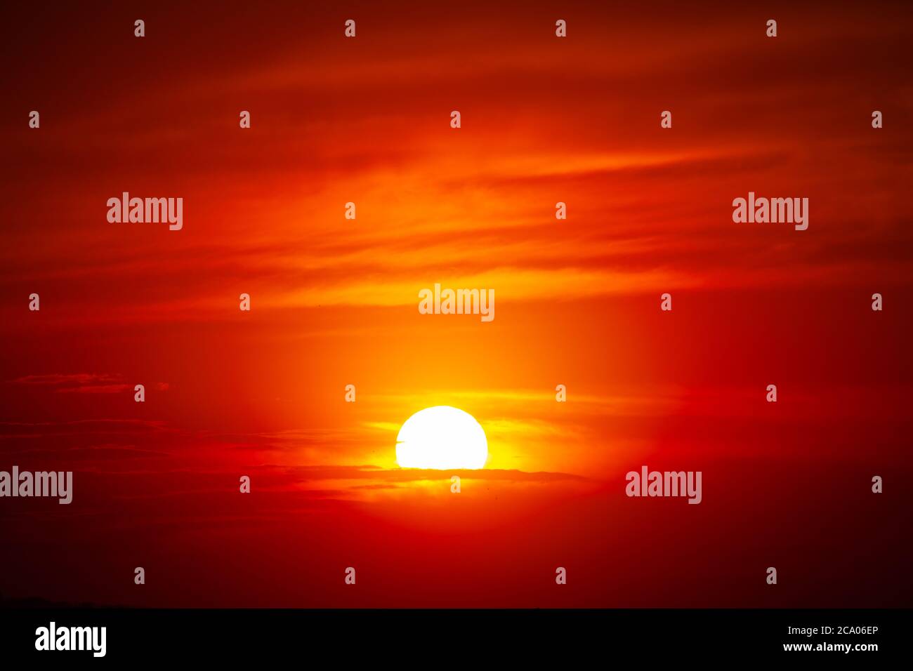 Awesome African Sunset . Big Sun Dial at the Red Sky Stock Photo - Alamy