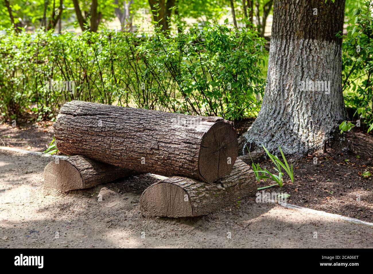 Bench made by big logs . Ecological green park Stock Photo - Alamy