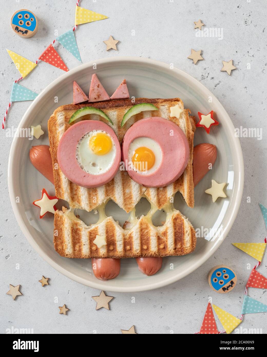 Monster sandwich with sausage, eggs and cheese on plate Stock Photo - Alamy