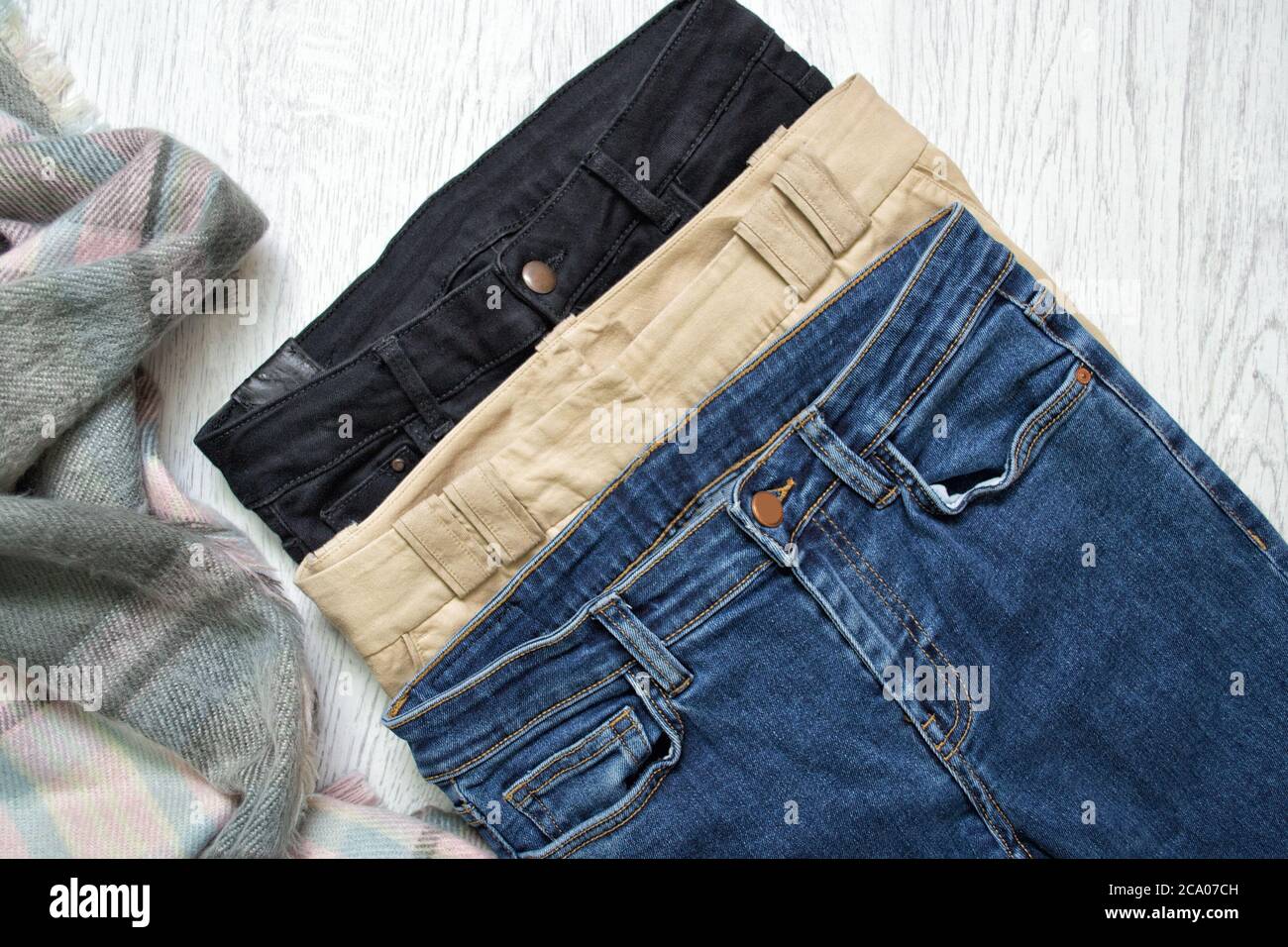 Three jeans, assortment. Blue, beige and black. Fashionable concept Stock Photo - Alamy