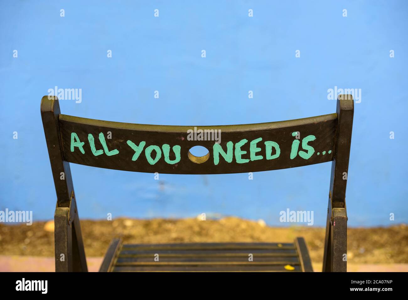 Wooden chair with written message on the back at the beach Stock Photo ...