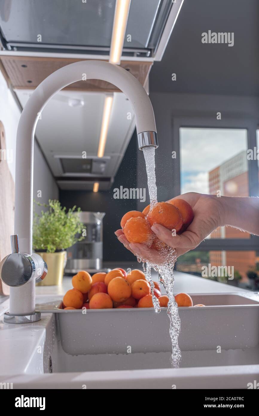 Hand washing fruit hi-res stock photography and images - Alamy