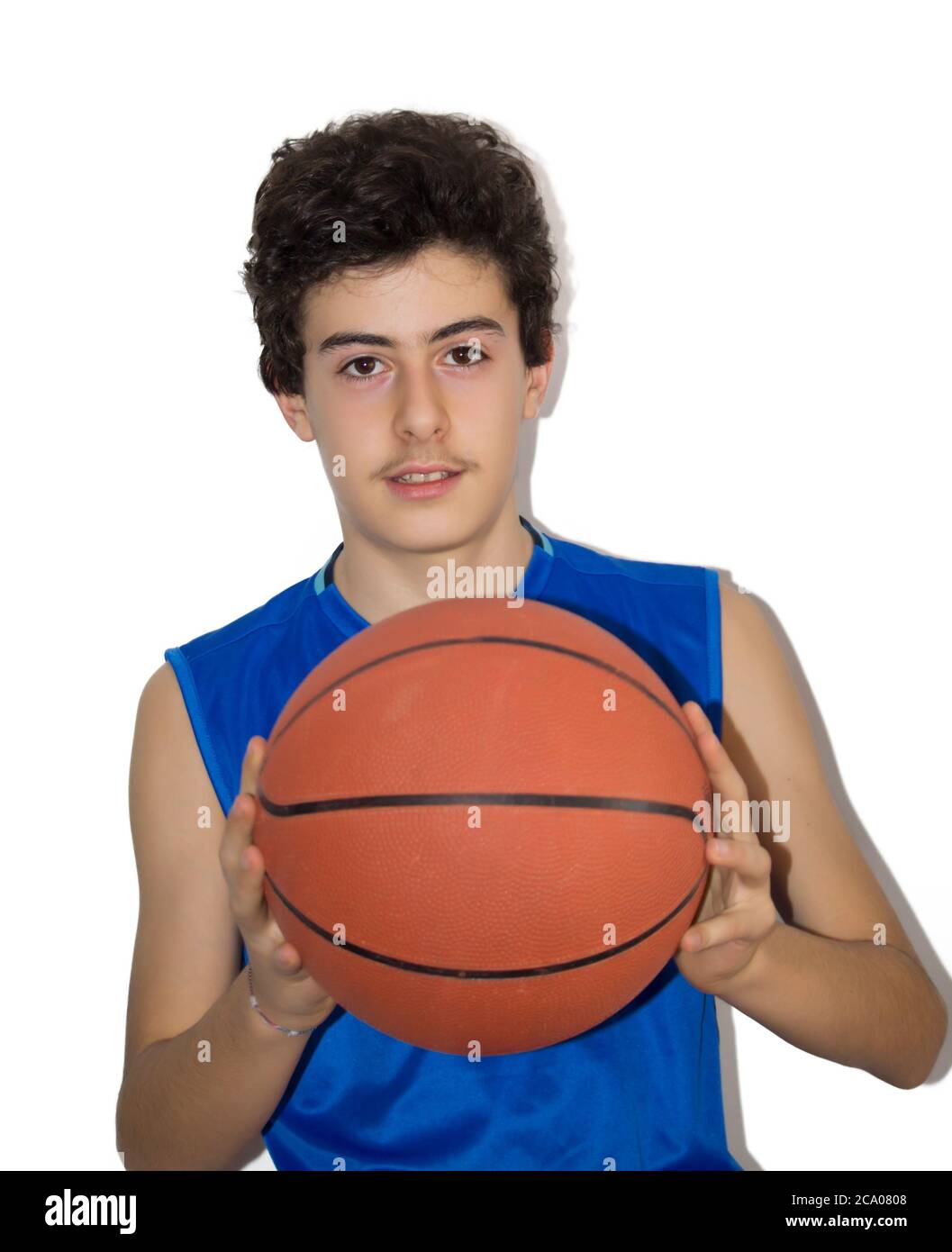 Young boy playing basketball in a isolated background Stock Photo - Alamy