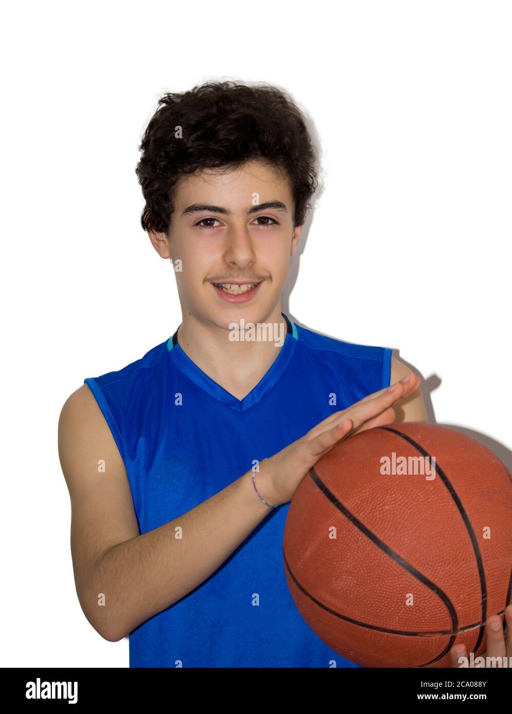 Young boy playing basketball in a isolated background Stock Photo - Alamy