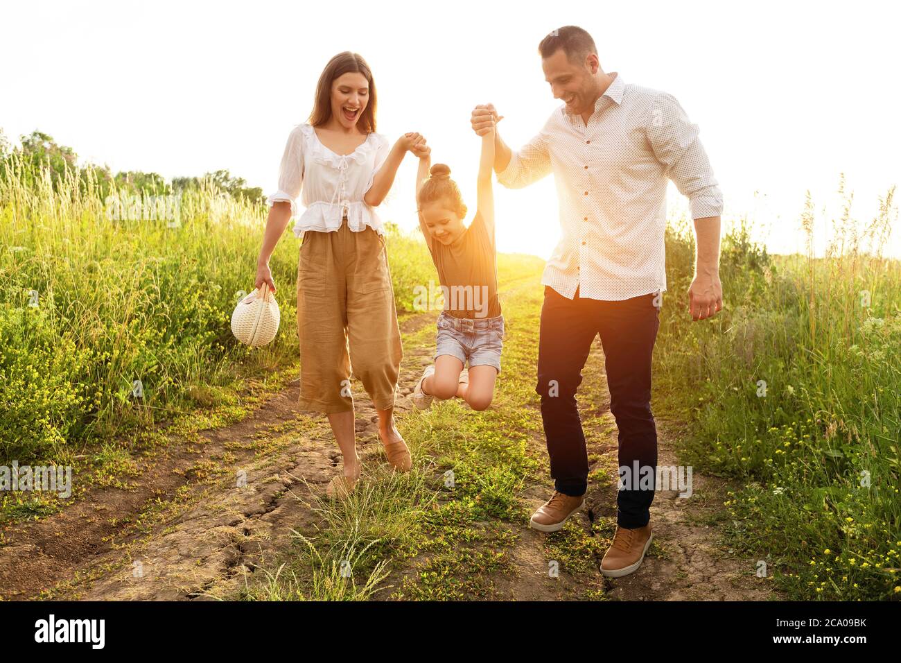 Happy family playing in the green field hi-res stock photography and ...