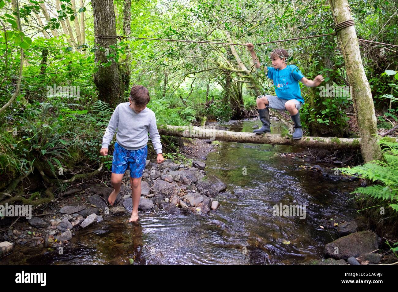 Children on summer holiday after lockdown playing in a stream in the ...