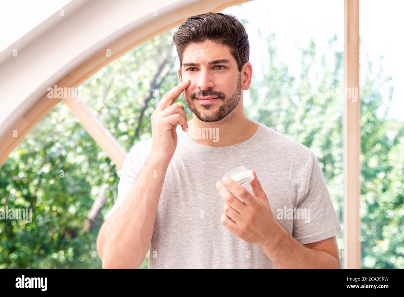 Applying moisturizer at bathroom mirror hi-res stock photography and images - Alamy
