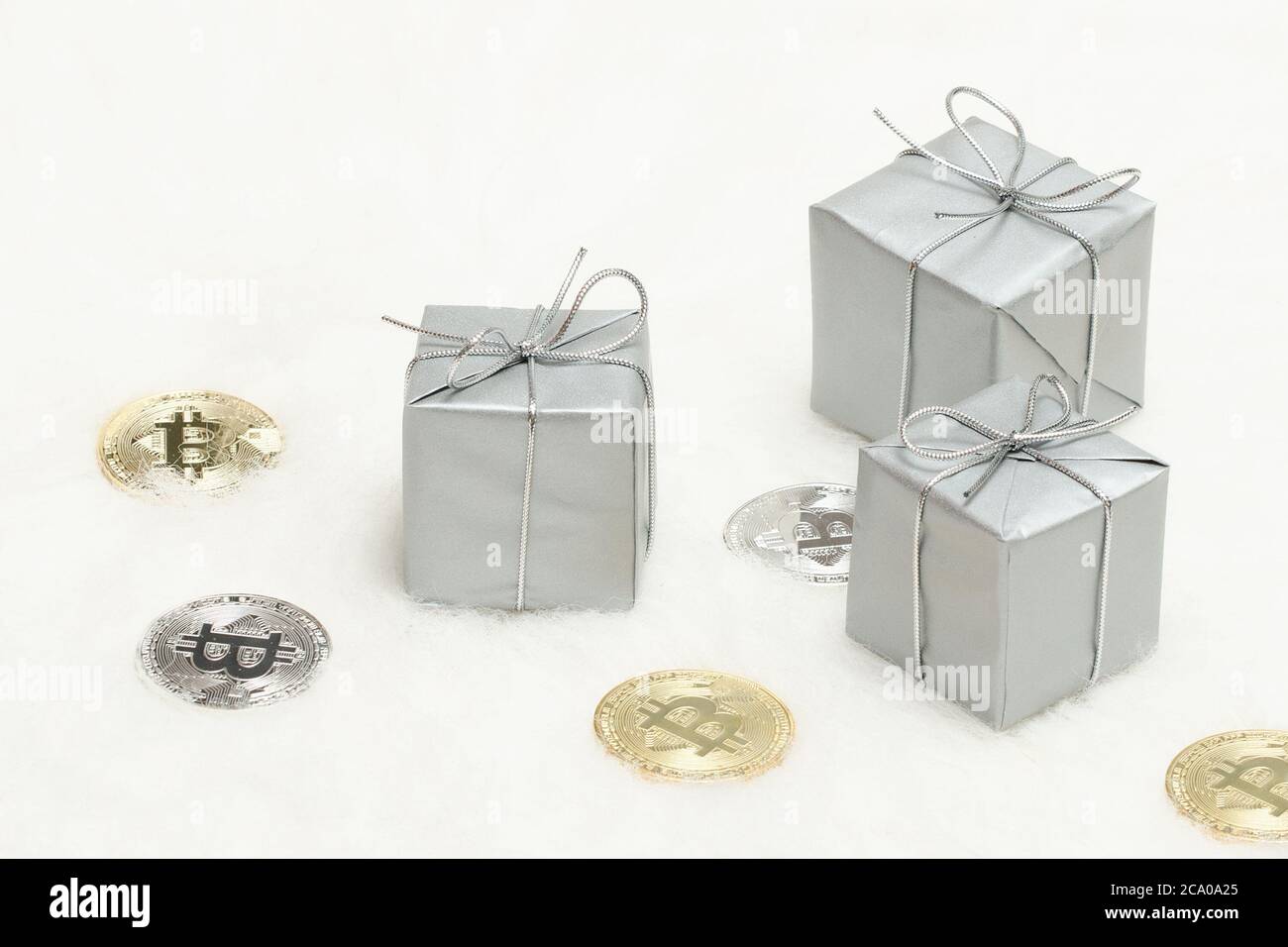 Silvery gift boxes and bitcoins coins on a white background Stock Photo ...