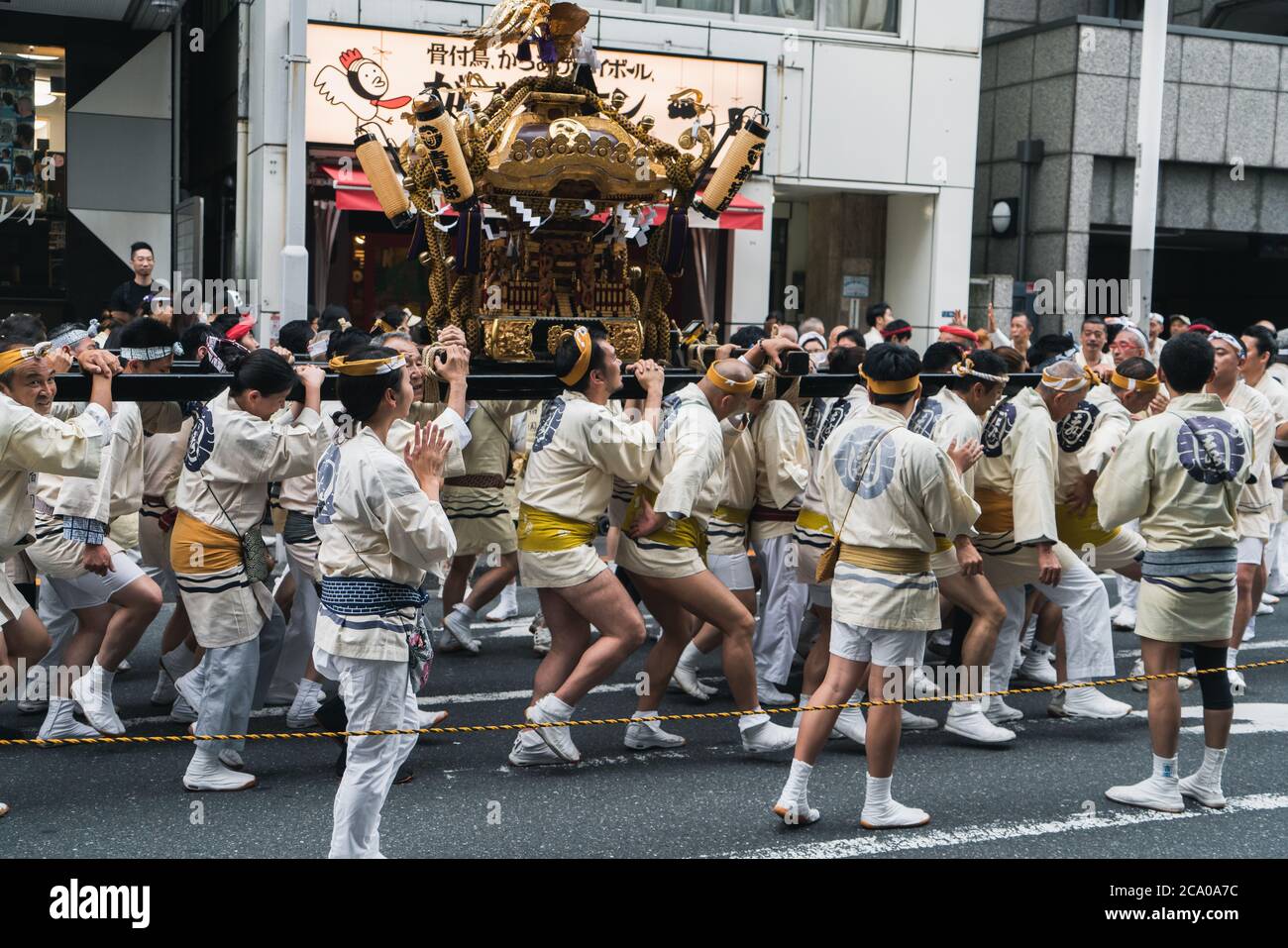 Crowds of japanese people carrying Shinto Shrine Mikoshi around the ...
