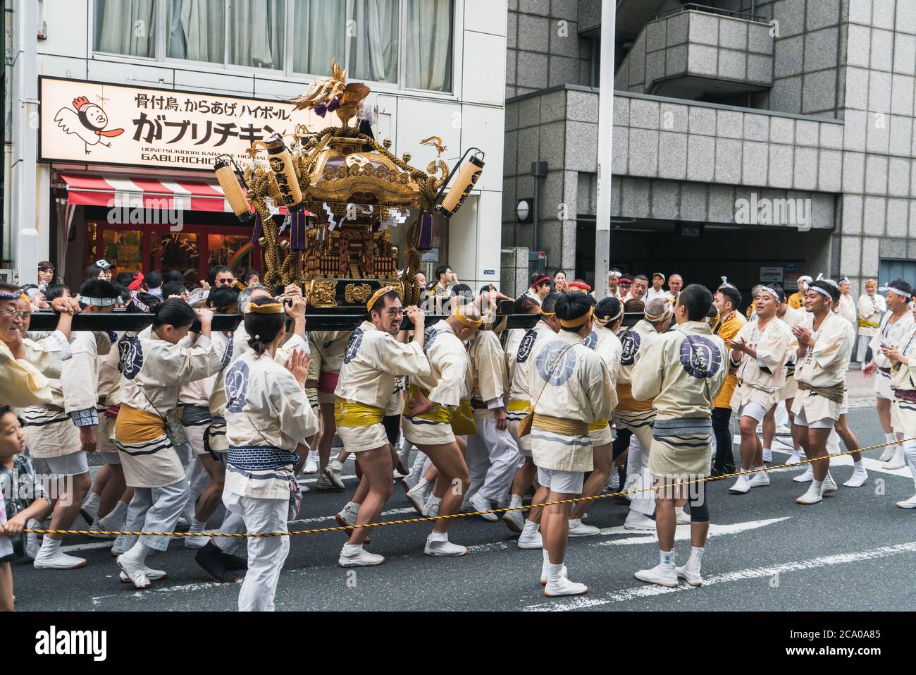 Crowds of japanese people carrying Shinto Shrine Mikoshi around the ...