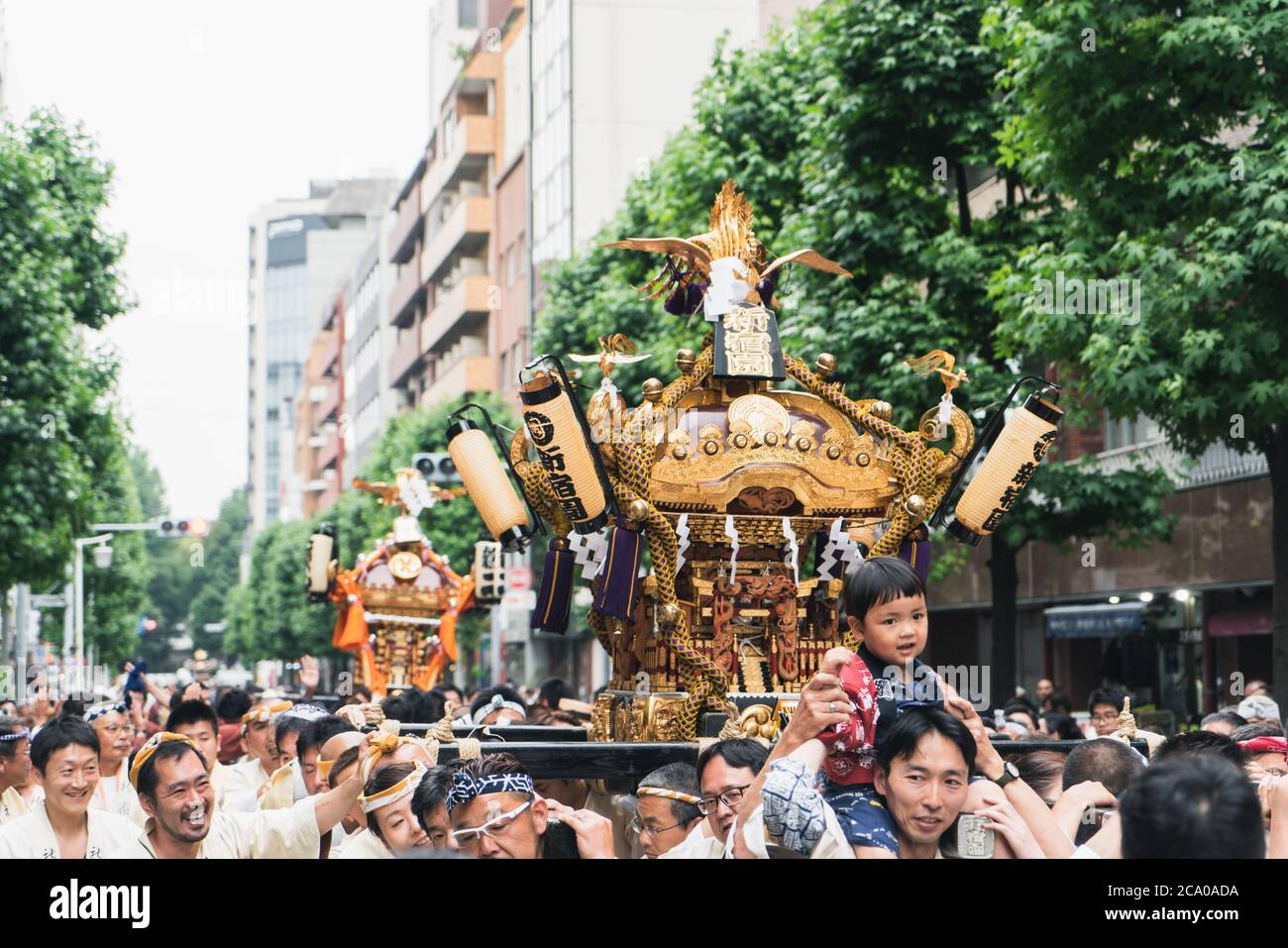 Crowds of japanese people carrying Shinto Shrine Mikoshi around the ...