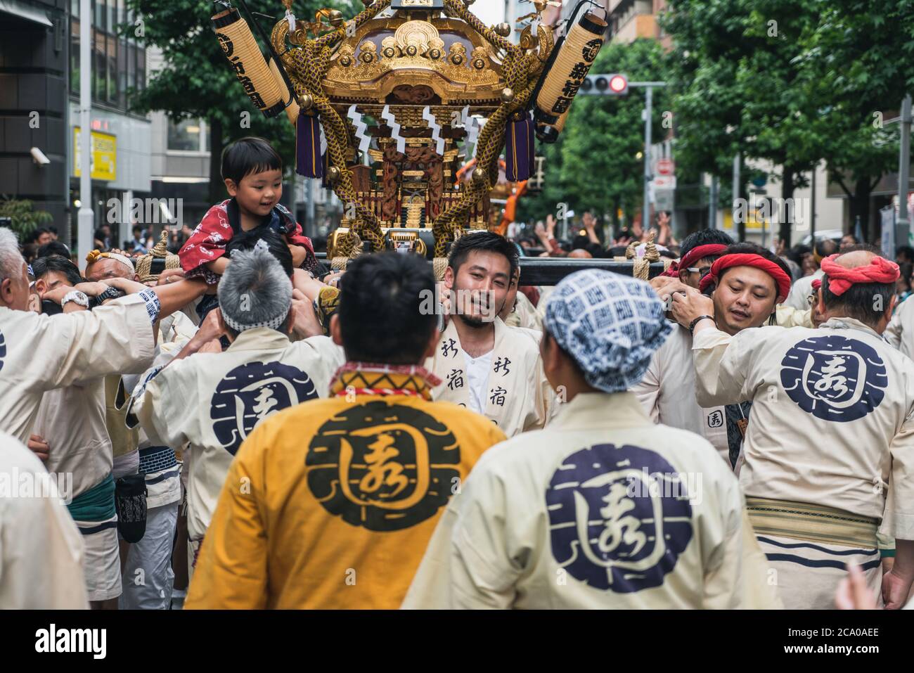 Crowds of japanese people carrying Shinto Shrine Mikoshi around the ...
