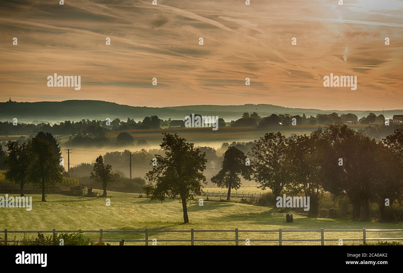landscape in the nature of the begium hills with haze , mist and hills ...